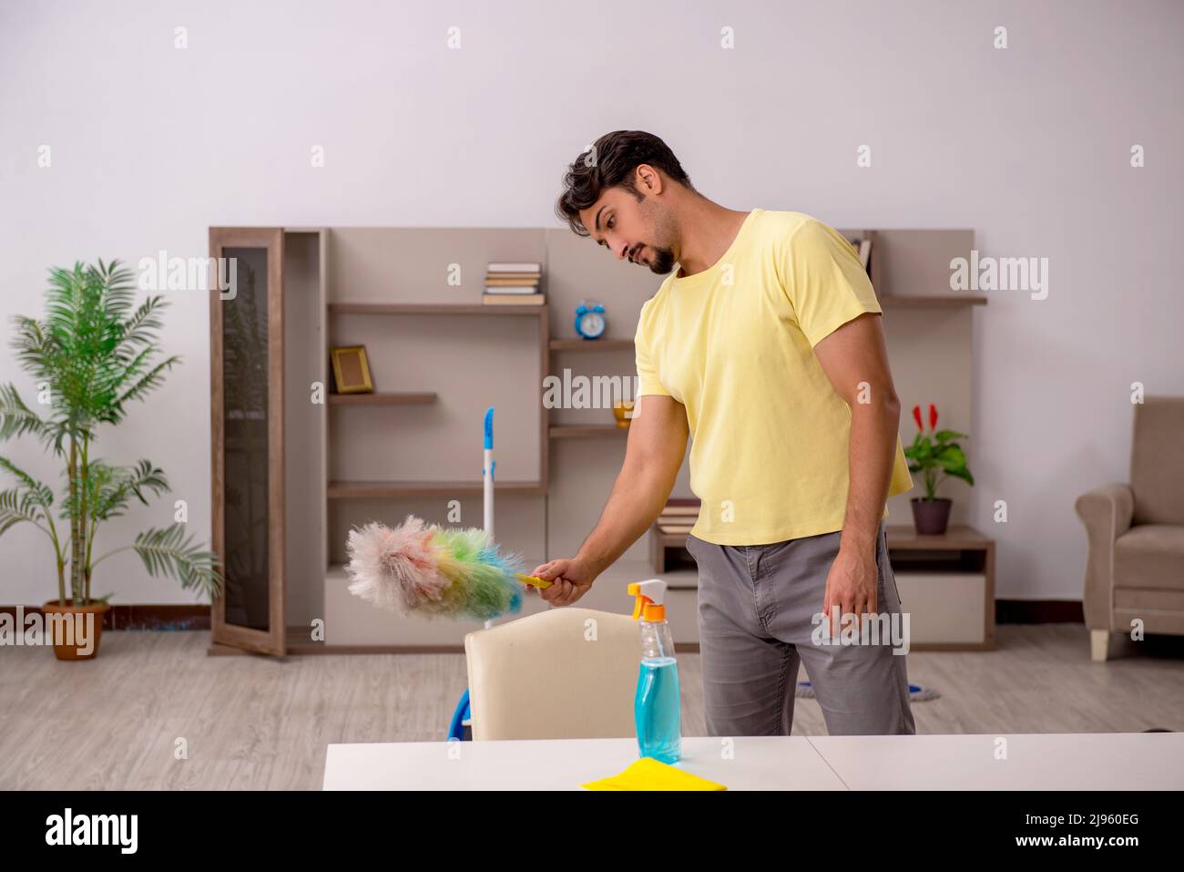 Young man cleaning the house Stock Photo - Alamy