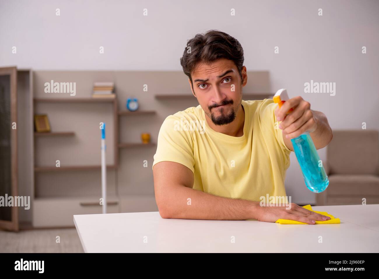 Young man cleaning the house Stock Photo - Alamy