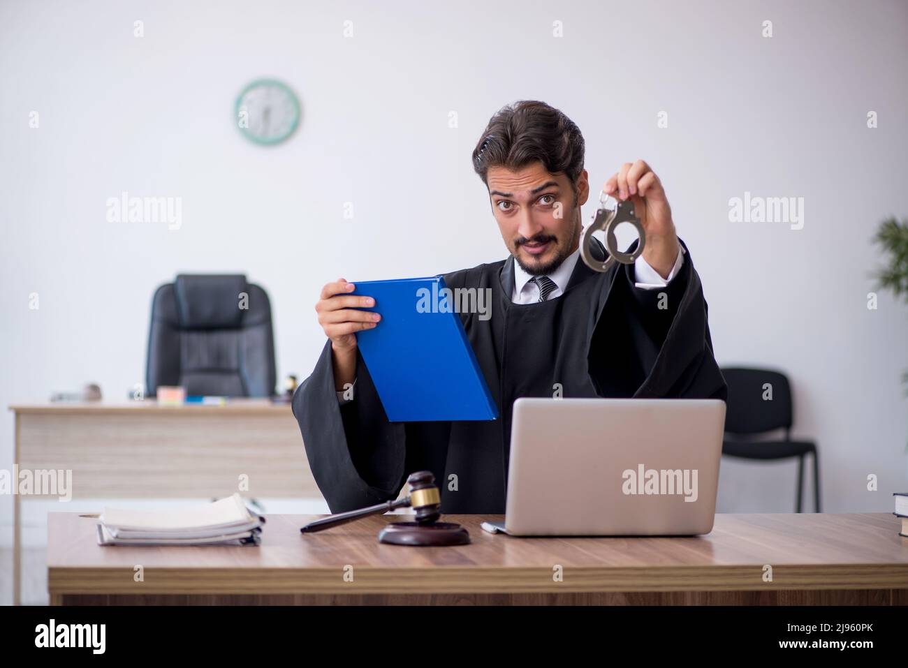 Young judge working in the courthouse Stock Photo - Alamy