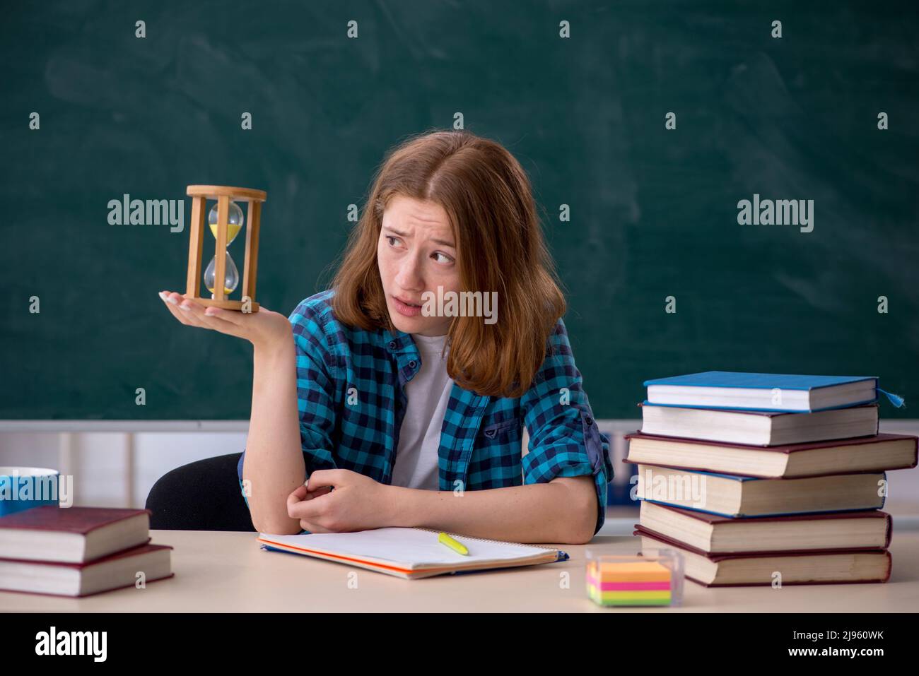 Young girl student in time management concept Stock Photo - Alamy