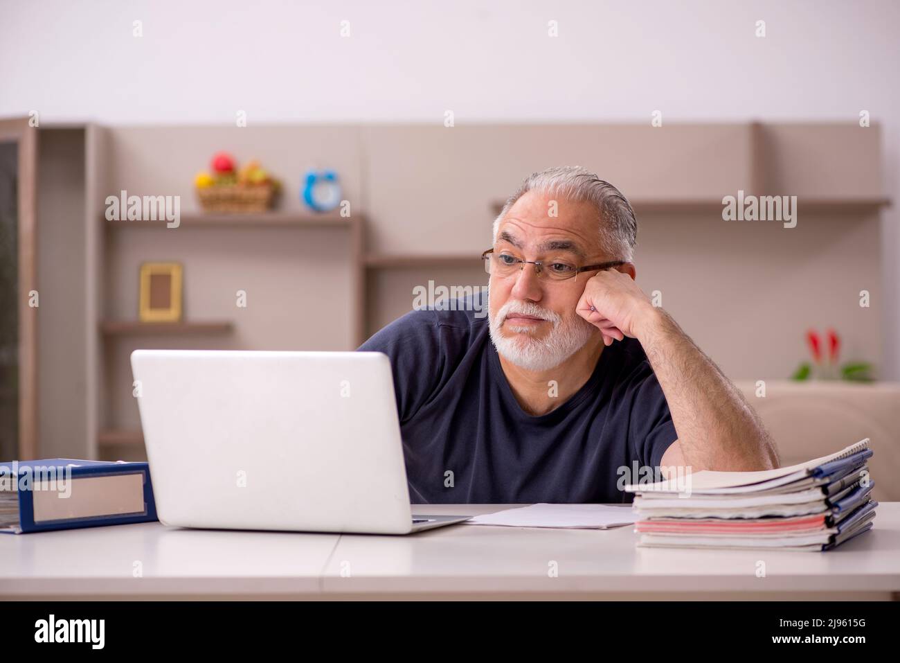 Old man employee working from home during pandemic Stock Photo - Alamy