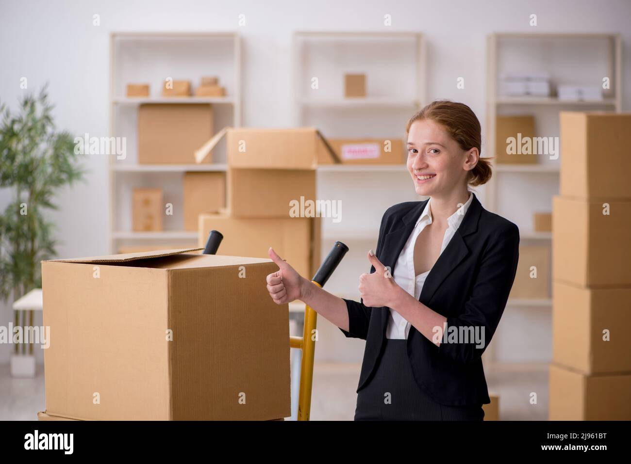 Female professional mover doing home relocation Stock Photo - Alamy
