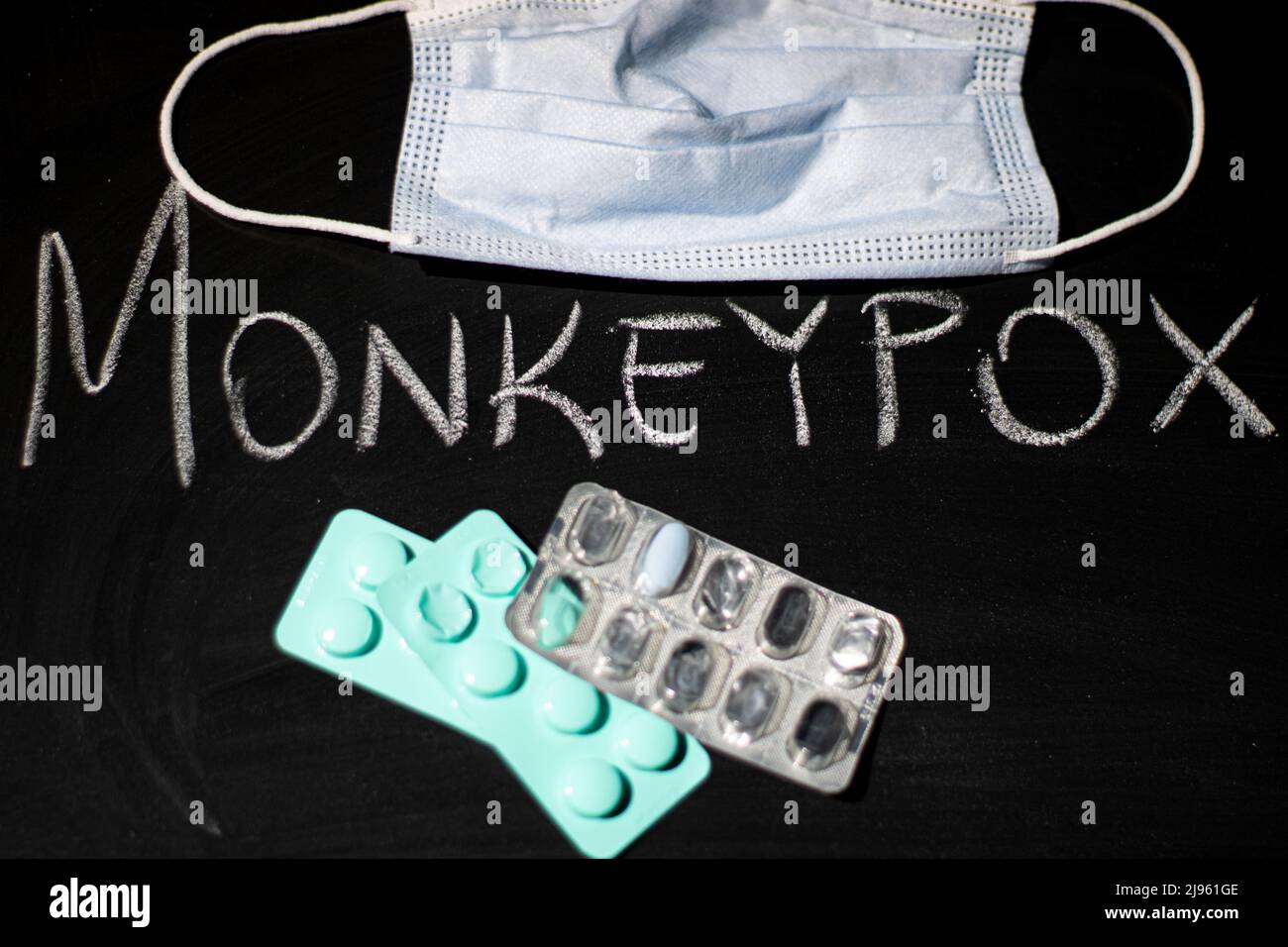 Monkeypox text with pills and a mask Stock Photo - Alamy