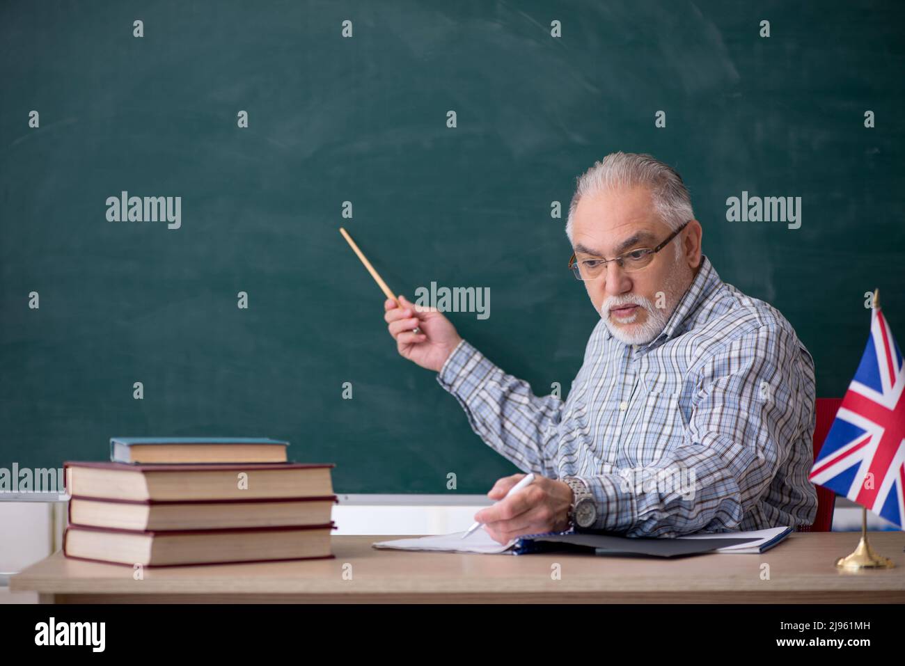 Aged english language teacher in the classroom Stock Photo - Alamy