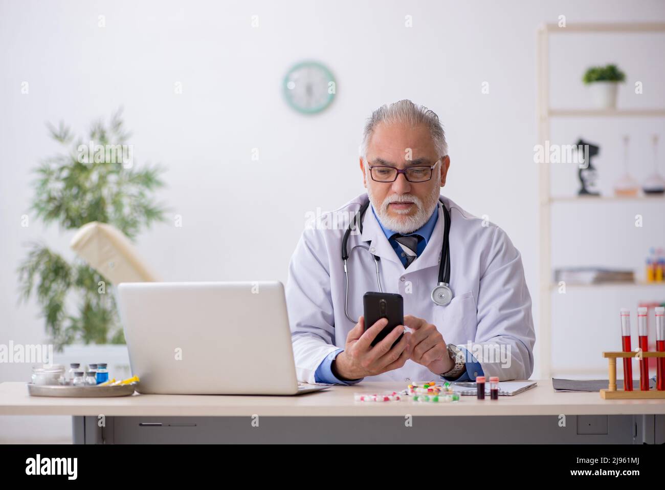 Old doctor pharmacist working at the lab Stock Photo - Alamy