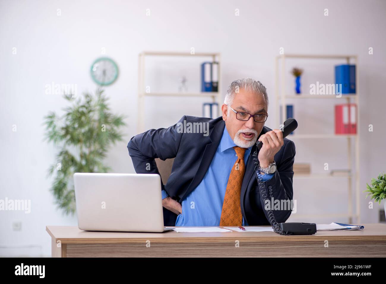 Old male employer working in the office Stock Photo - Alamy