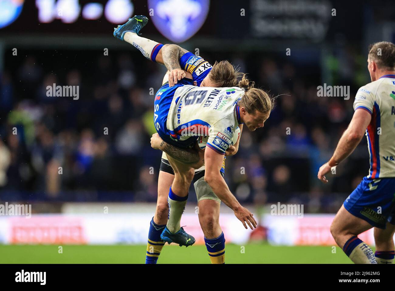Jacob Miller #6 of Wakefield Trinity is is tackled by Blake Austin of ...