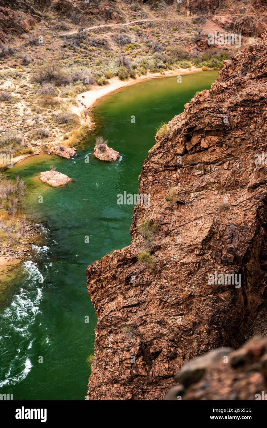 Bright Green Colorado River Passing Around The Orange Walls Of The ...