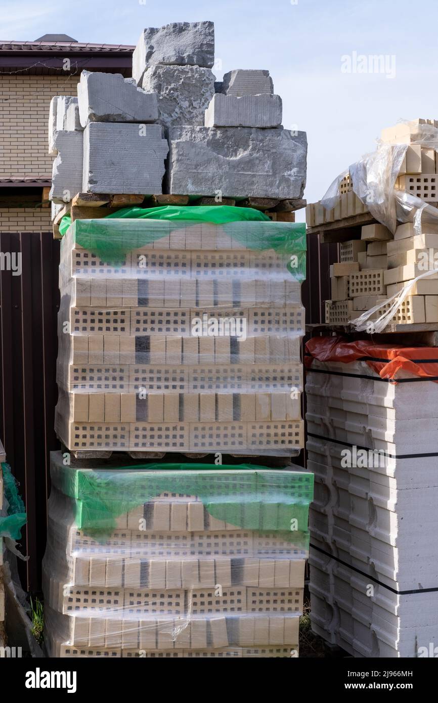 Home construction. Concrete blocks and brown bricks for building a ...