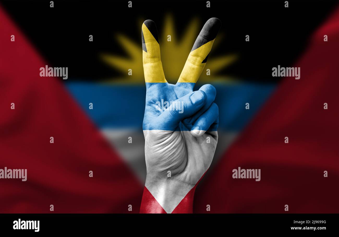 Hand making the V victory sign with flag of antigua barbuda Stock Photo ...