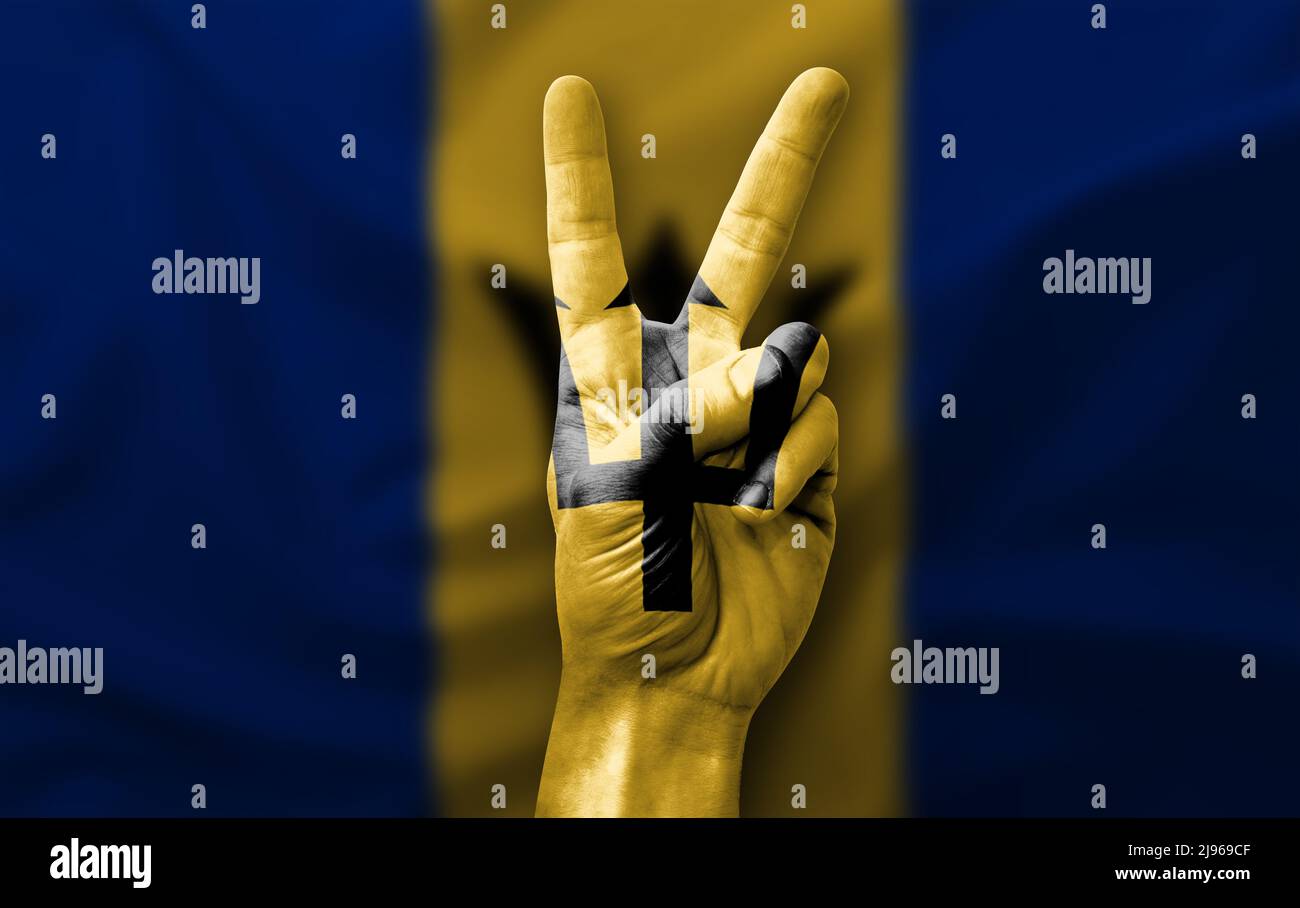 Hand making the V victory sign with flag of barbados Stock Photo - Alamy