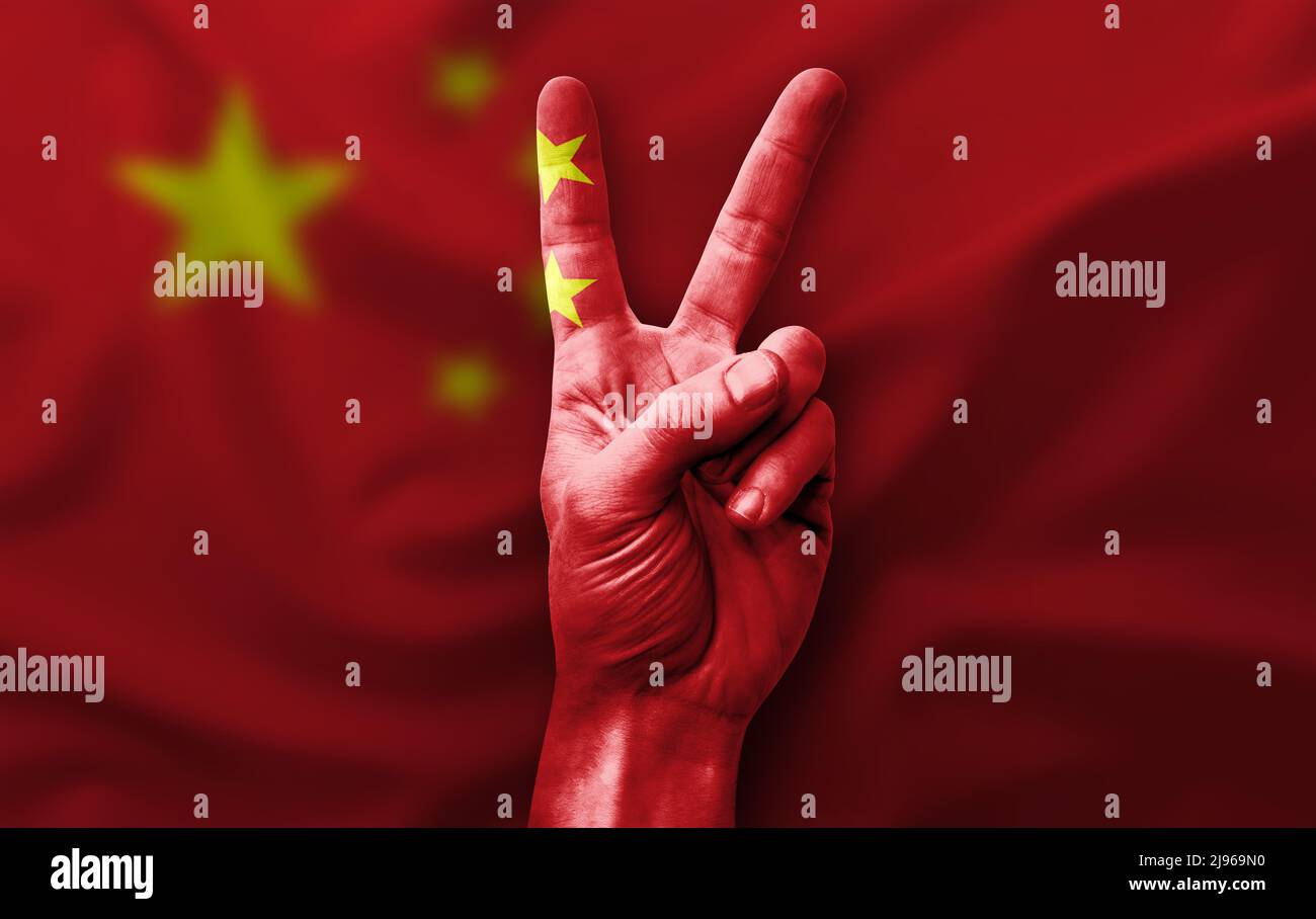 Hand making the V victory sign with flag of china Stock Photo - Alamy