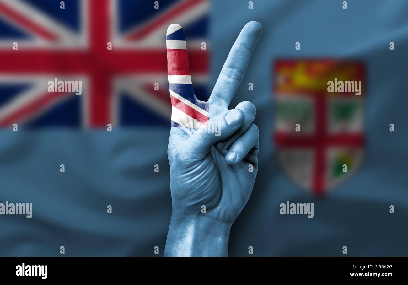 Hand making the V victory sign with flag of fiji Stock Photo - Alamy