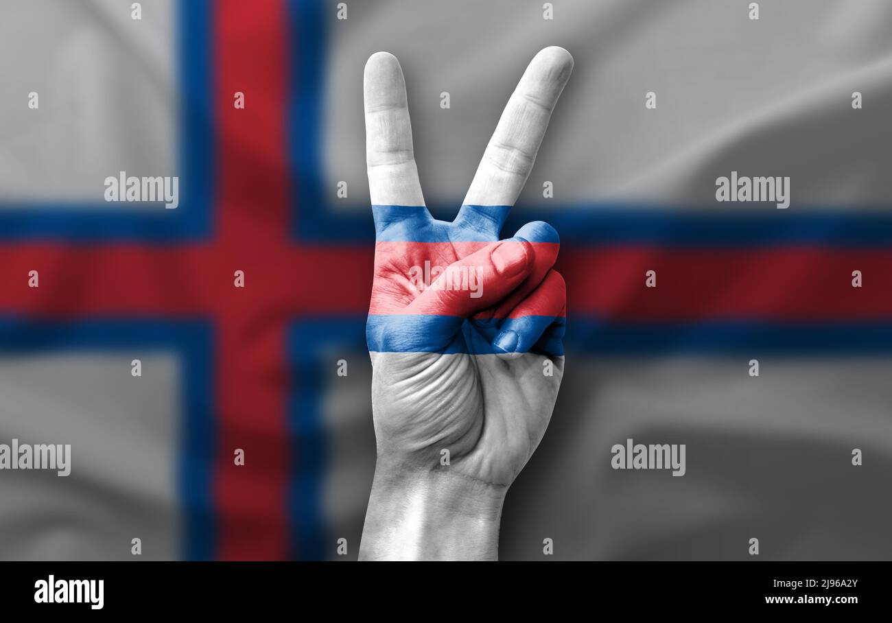 Hand making the V victory sign with flag of faroe islands Stock Photo ...