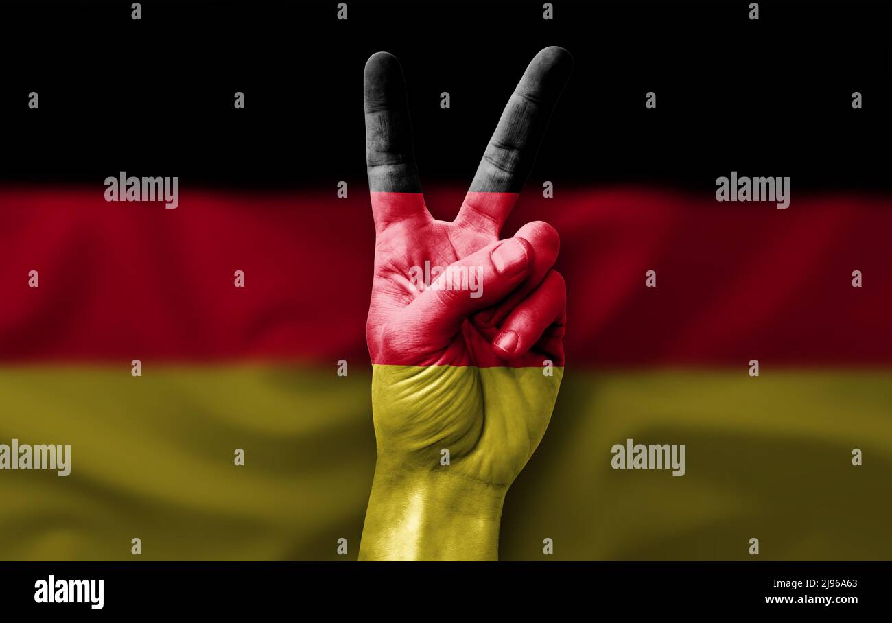 Hand making the V victory sign with flag of germany Stock Photo - Alamy