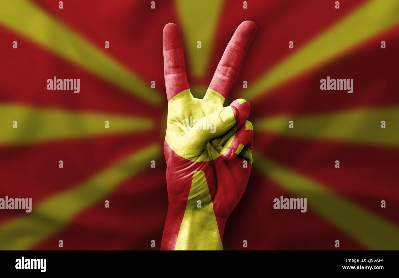 Hand making the V victory sign with flag of north macedonia Stock Photo ...