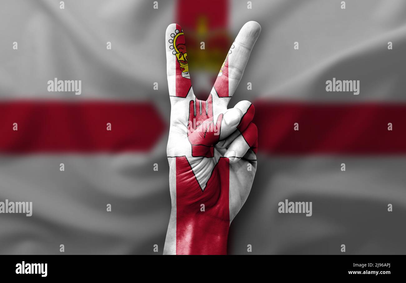 Hand making the V victory sign with flag of northern ireland Stock ...