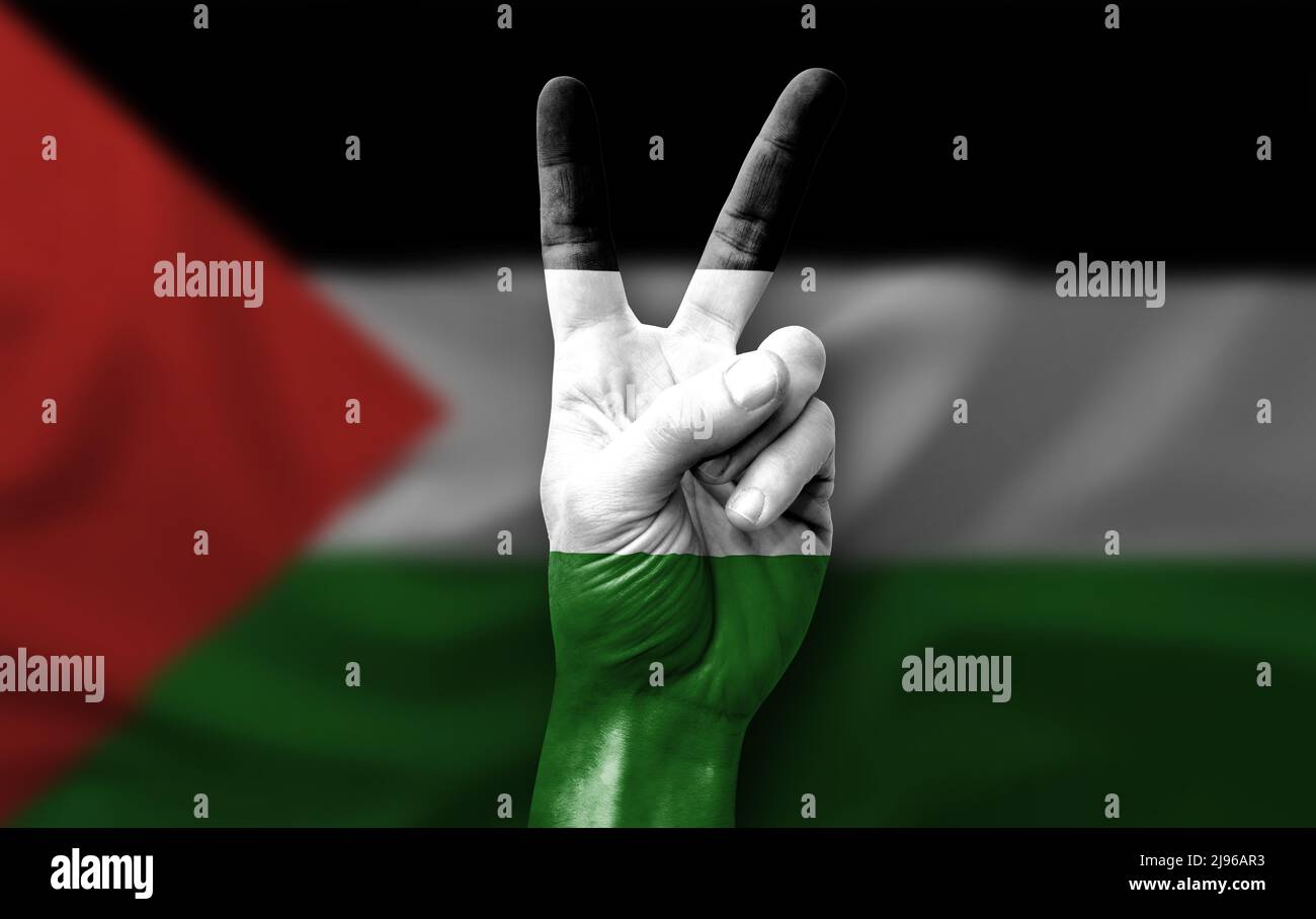 Hand making the V victory sign with flag of palestine Stock Photo - Alamy