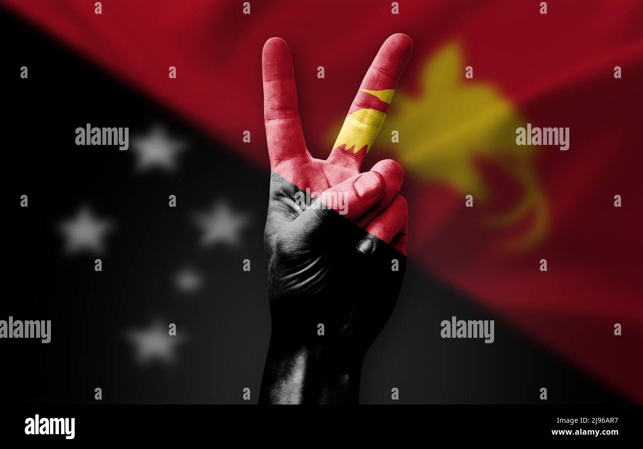 Hand making the V victory sign with flag of papua new guinea Stock ...