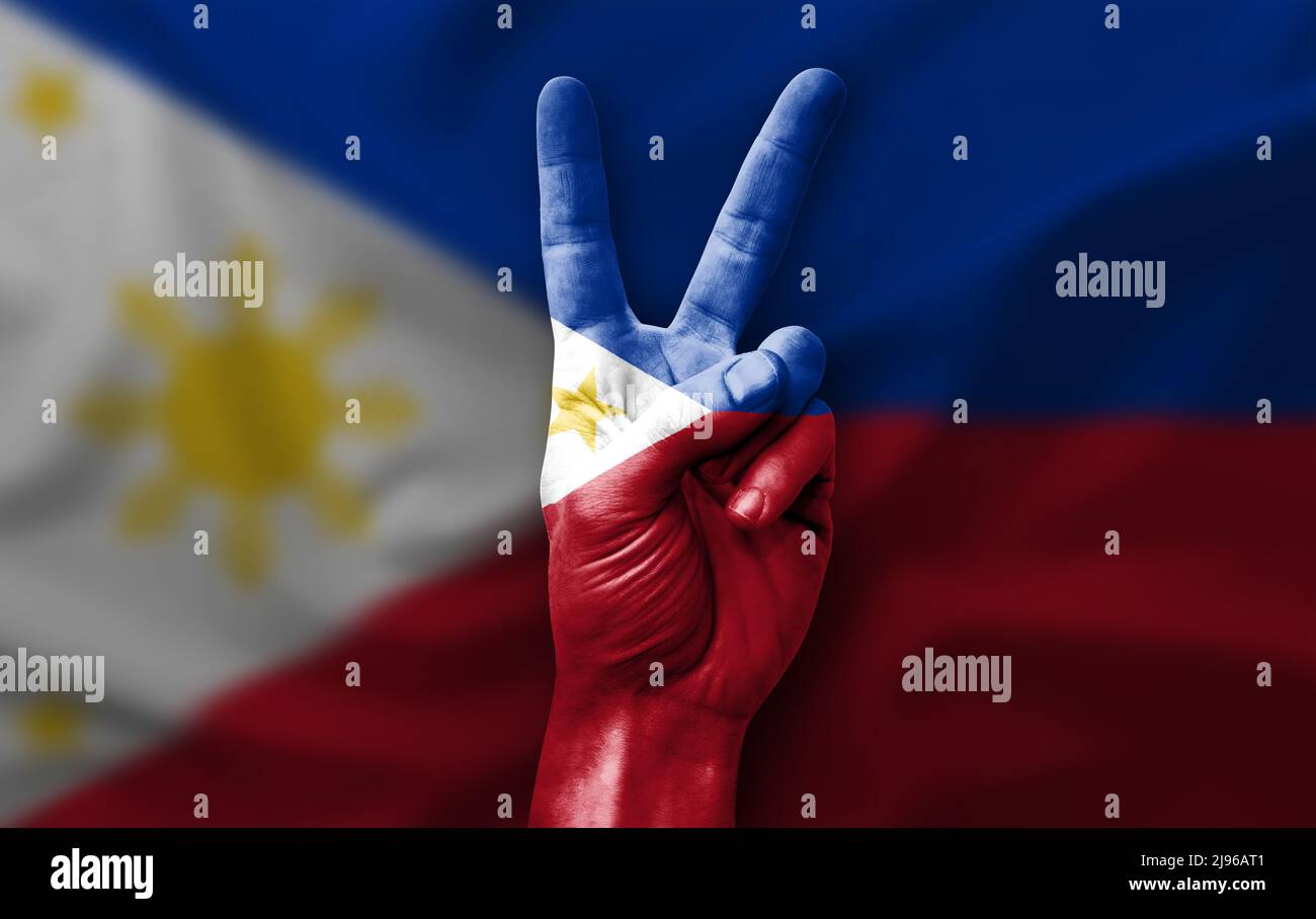 Hand making the V victory sign with flag of philippines Stock Photo - Alamy
