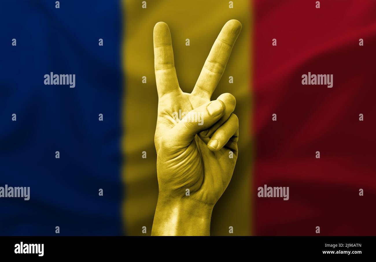 Hand making the V victory sign with flag of romania Stock Photo - Alamy