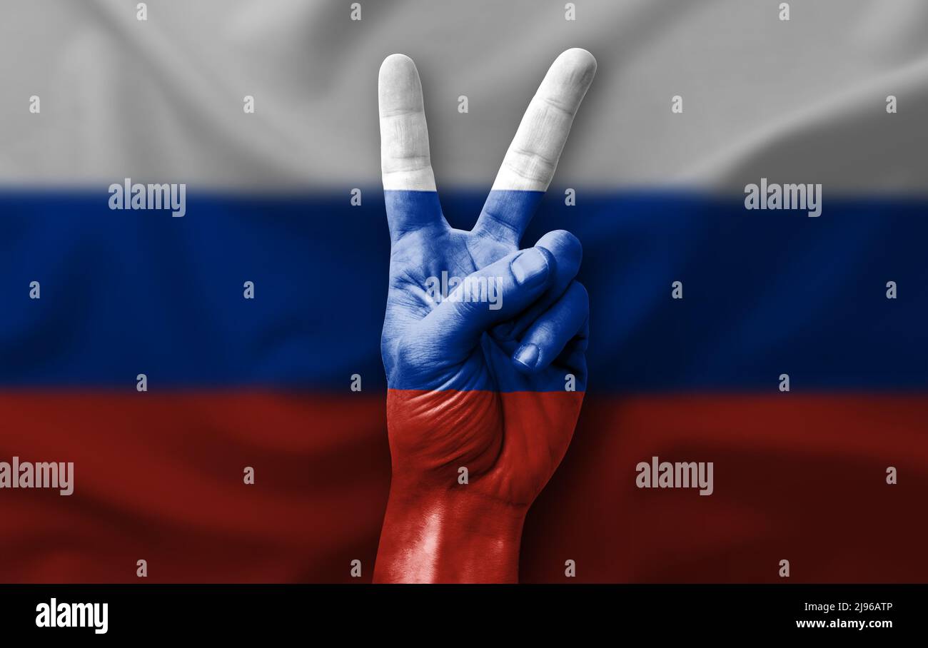 Hand making the V victory sign with flag of russia Stock Photo - Alamy