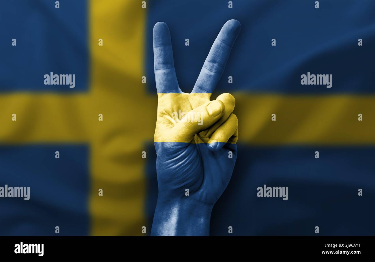 Hand making the V victory sign with flag of sweden Stock Photo - Alamy
