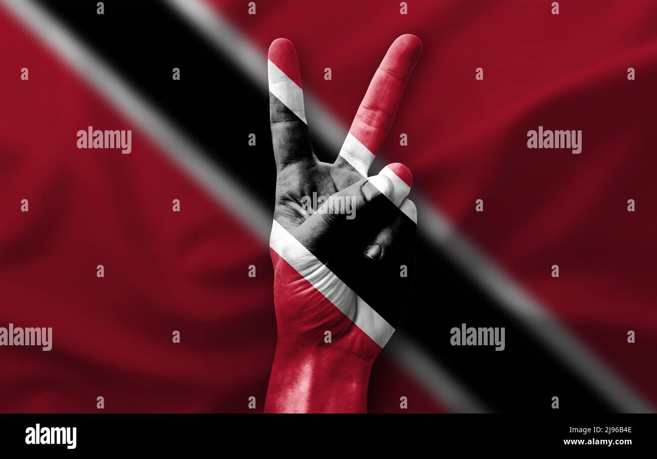 Hand making the V victory sign with flag of trinidad tobago Stock Photo ...