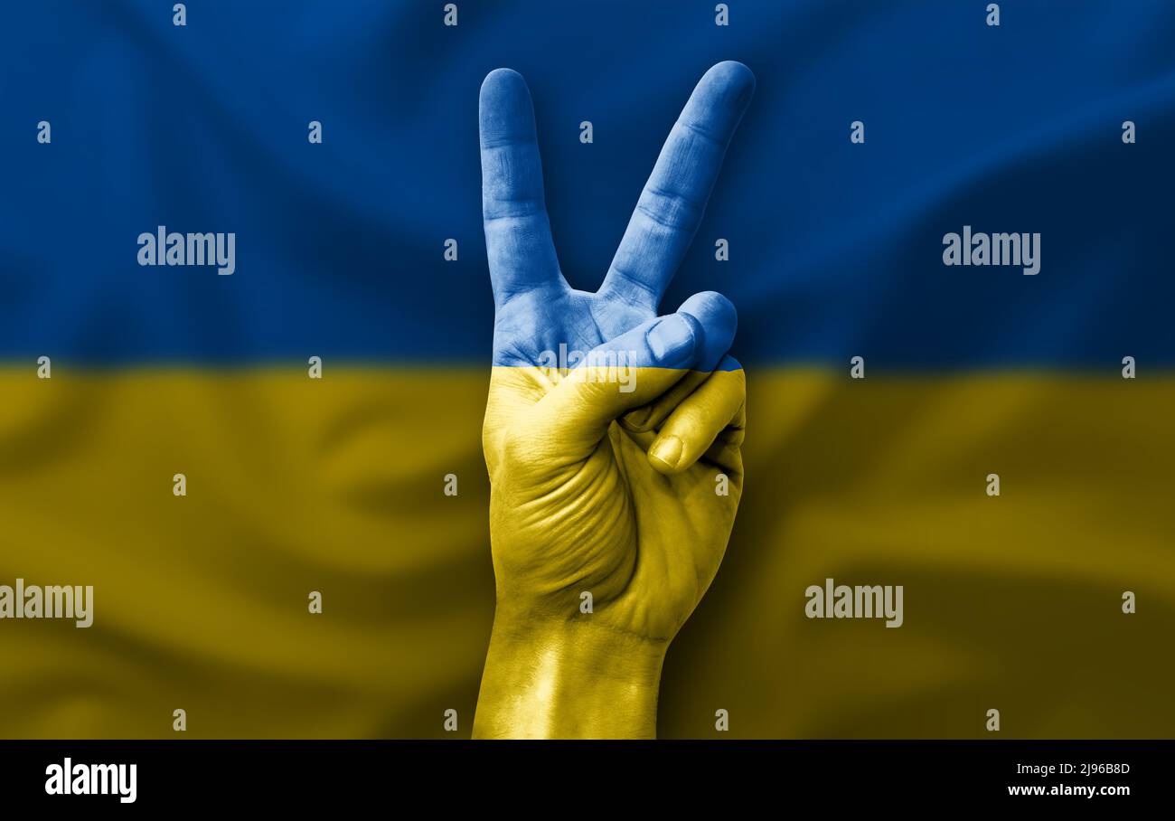 Hand making the V victory sign with flag of ukraine Stock Photo - Alamy
