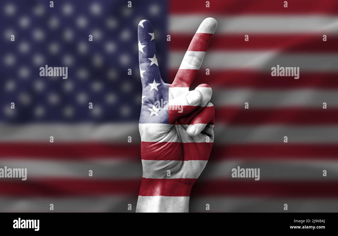 Hand making the V victory sign with flag of usa Stock Photo - Alamy