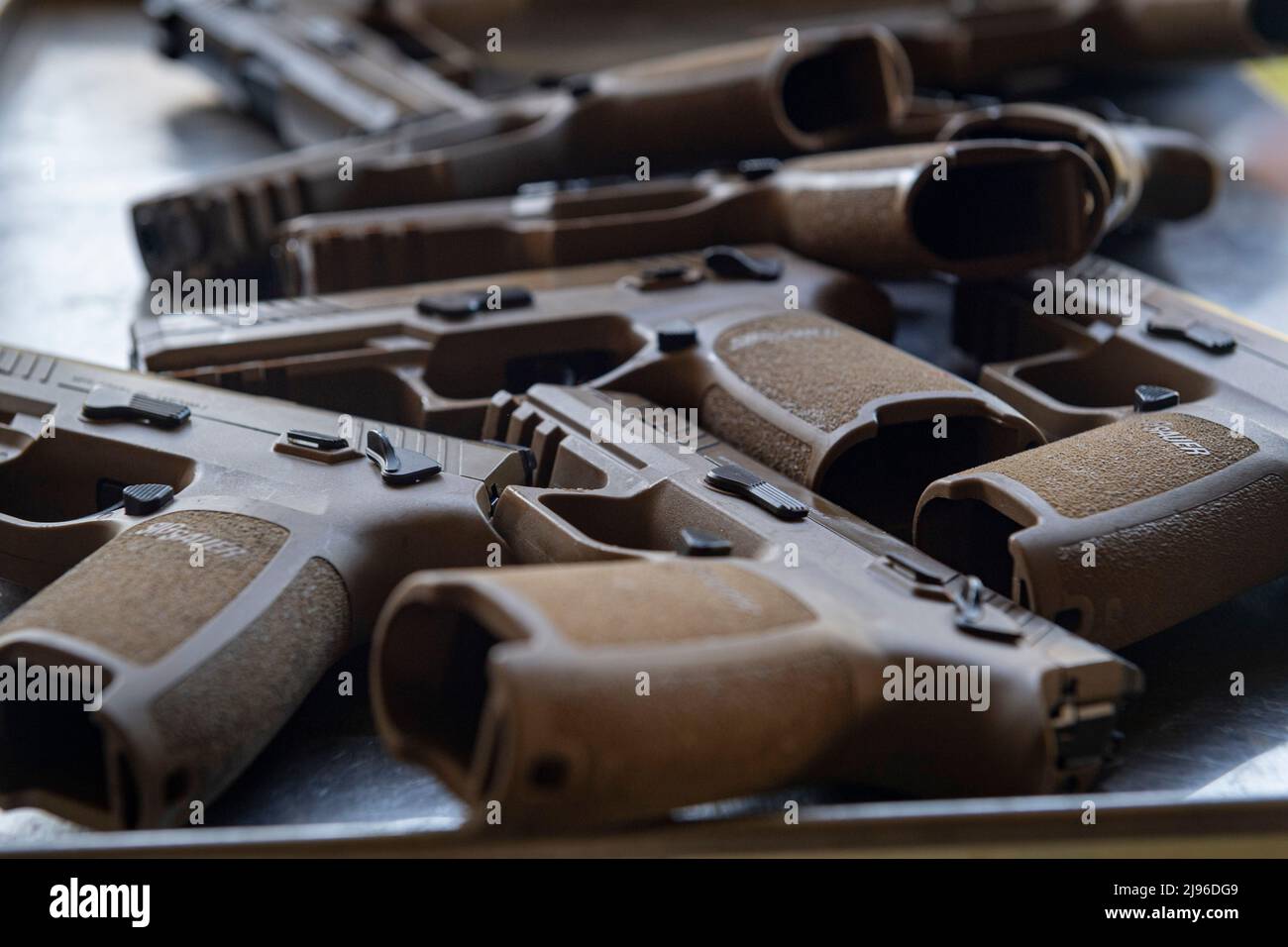 Sig Sauer M18 modular handguns sit on a table before an Excellence-In ...