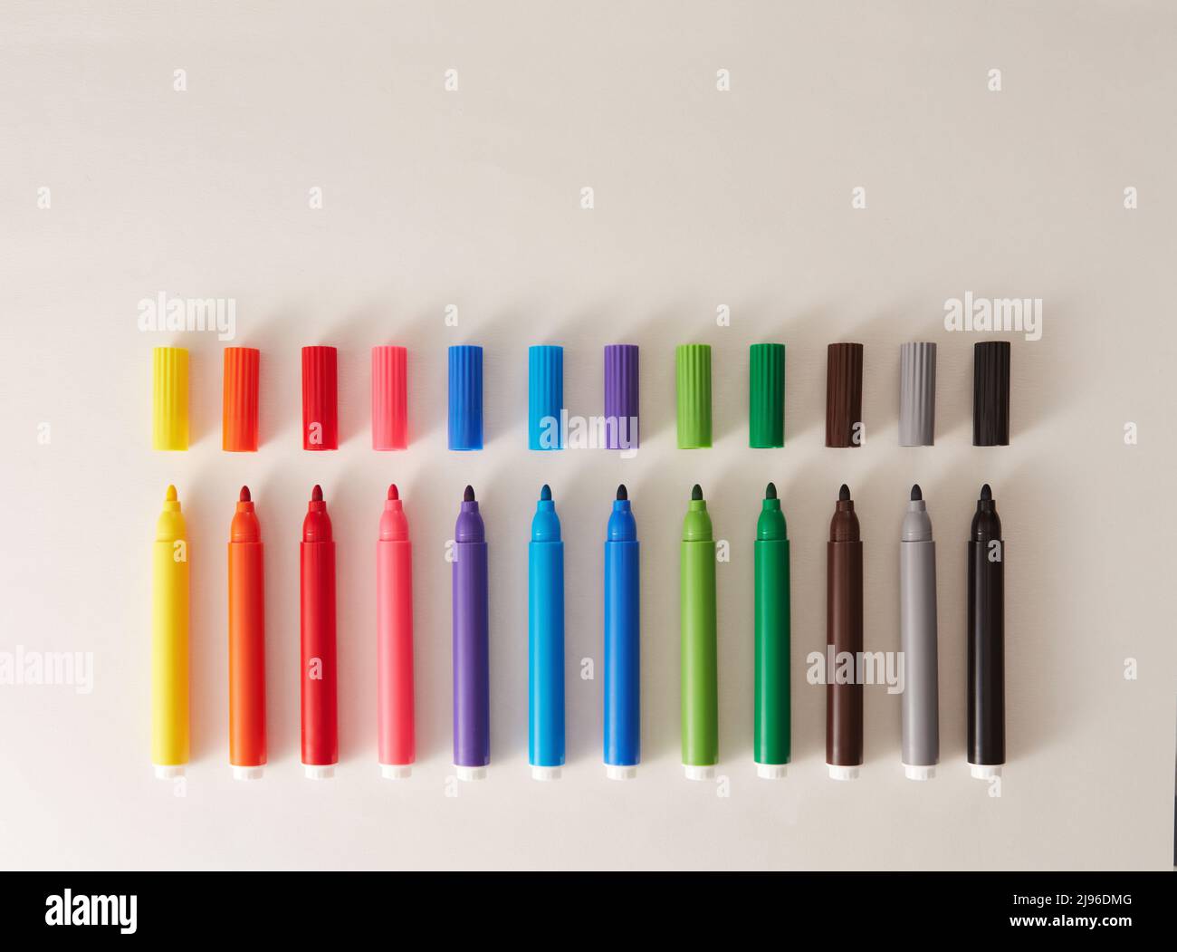 Colored markers on white background Stock Photo - Alamy