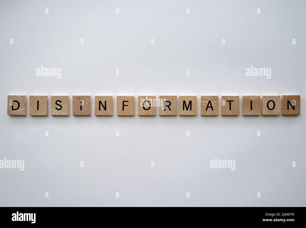 Disinformation concept with tile lettering Stock Photo - Alamy