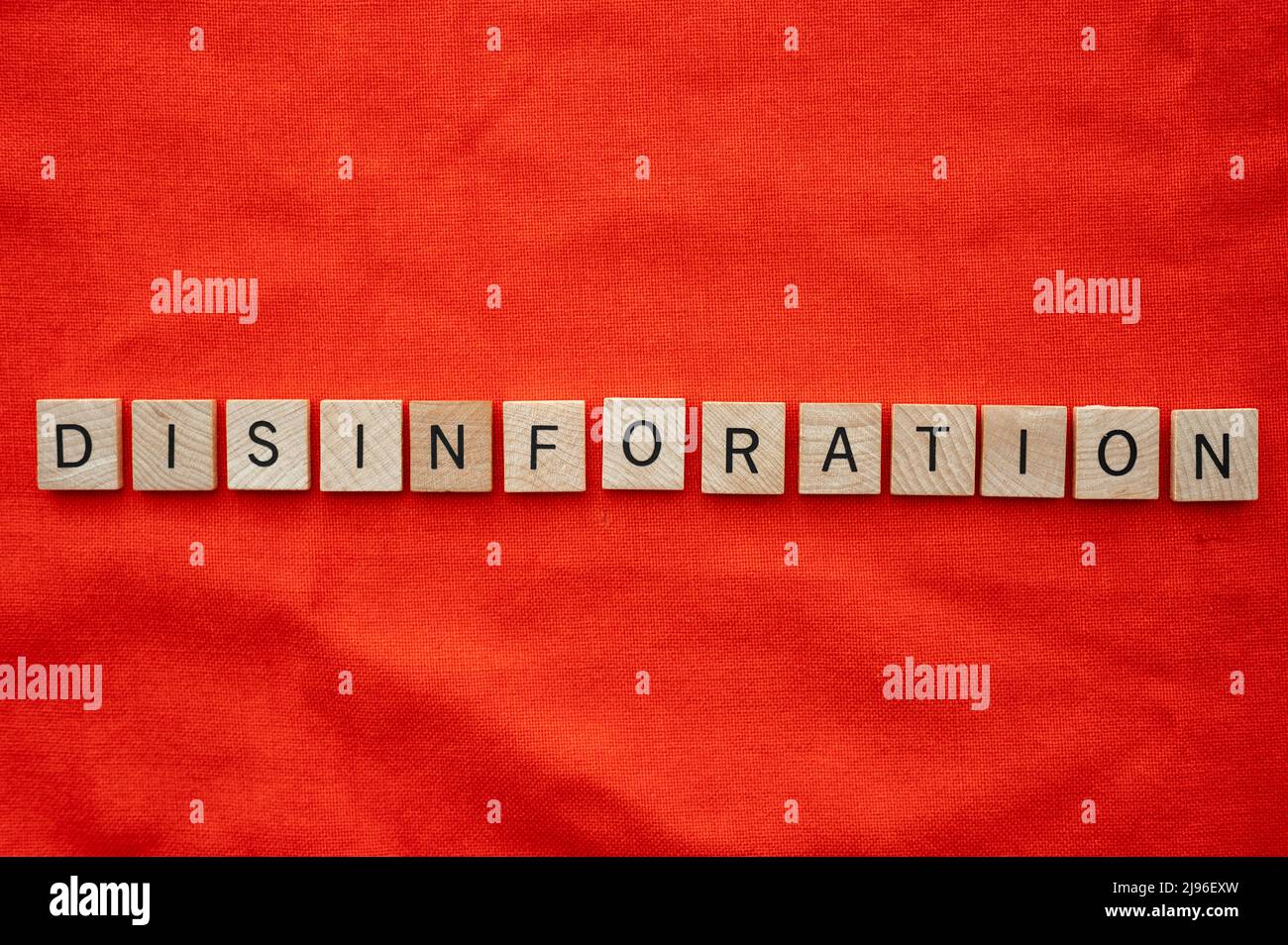 Disinformation concept with tile lettering Stock Photo - Alamy