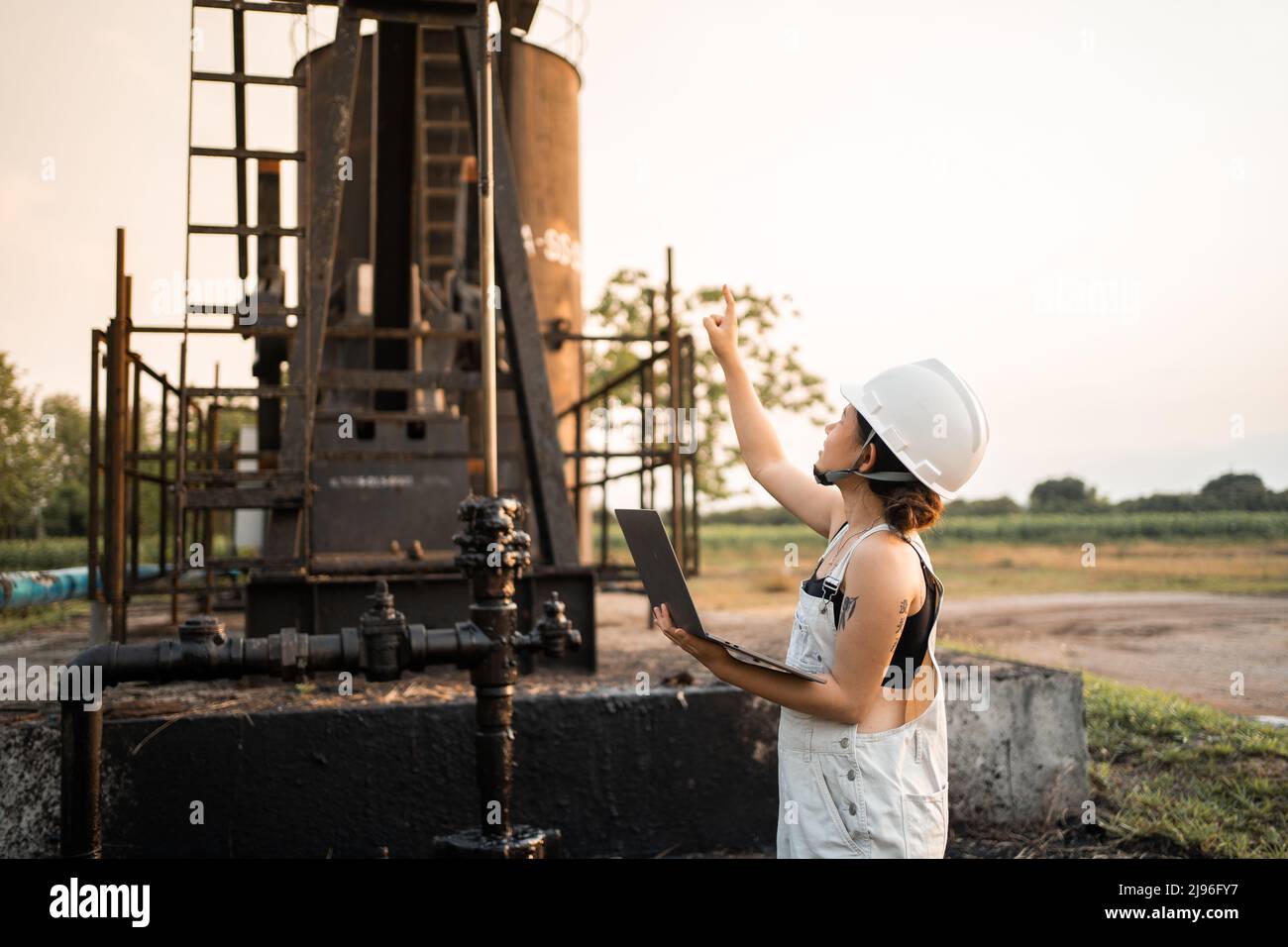 Petrochemical engineering asian woman with safety helmet standing in ...