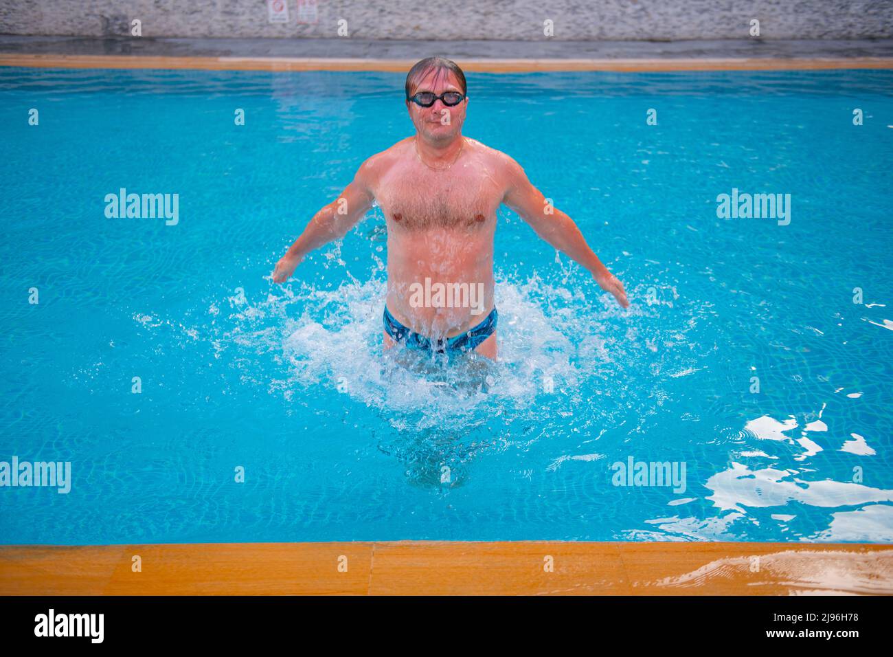 adult man diving the pool net in a hotel in summer Stock Photo - Alamy