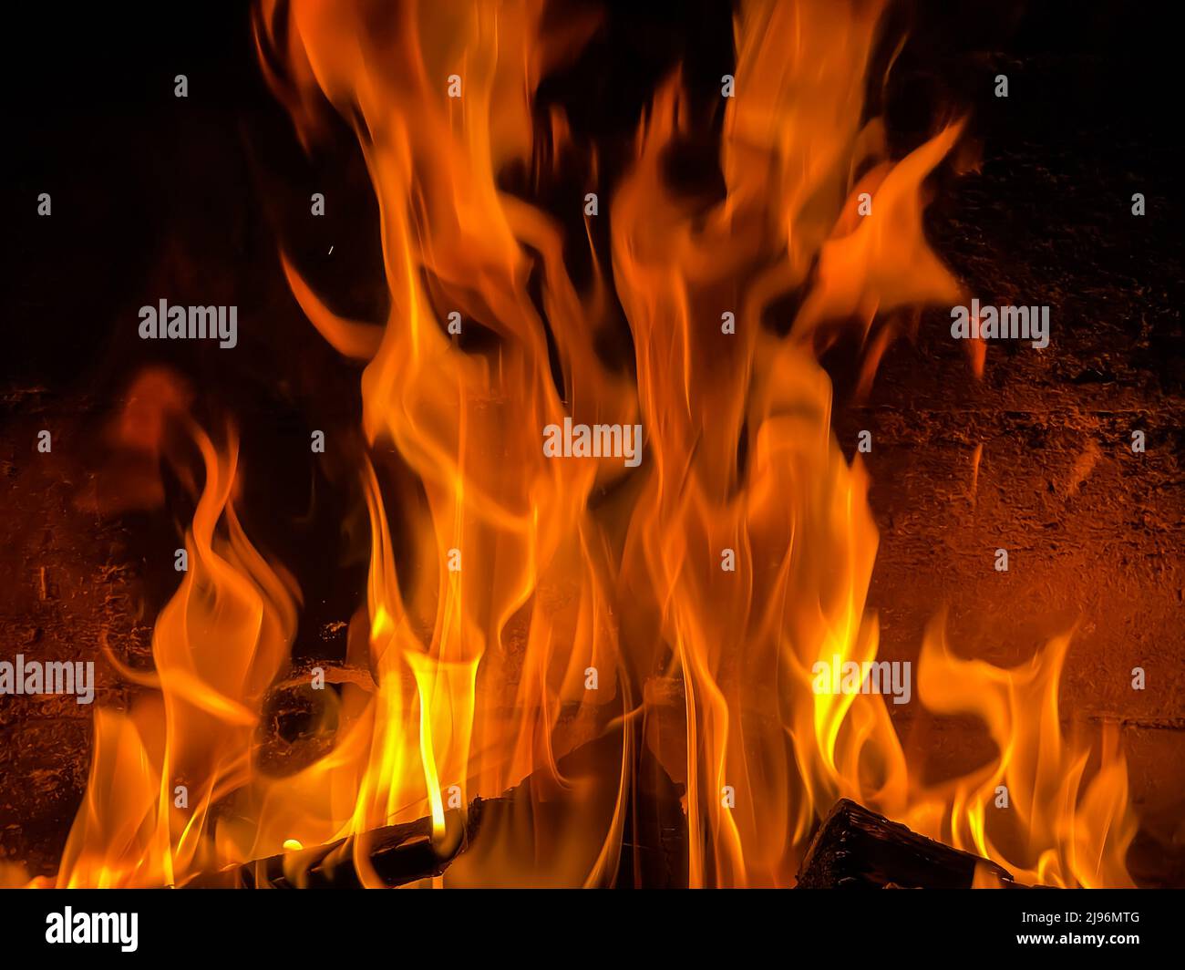 Flames of fire on a black background. Burning wood in the fireplace ...