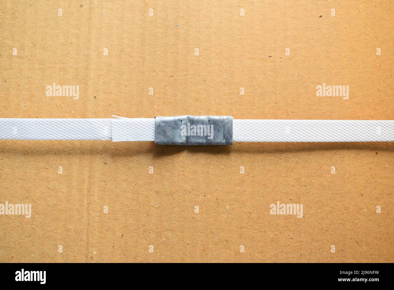 Metal closed packaging clip on cardboard box Stock Photo - Alamy