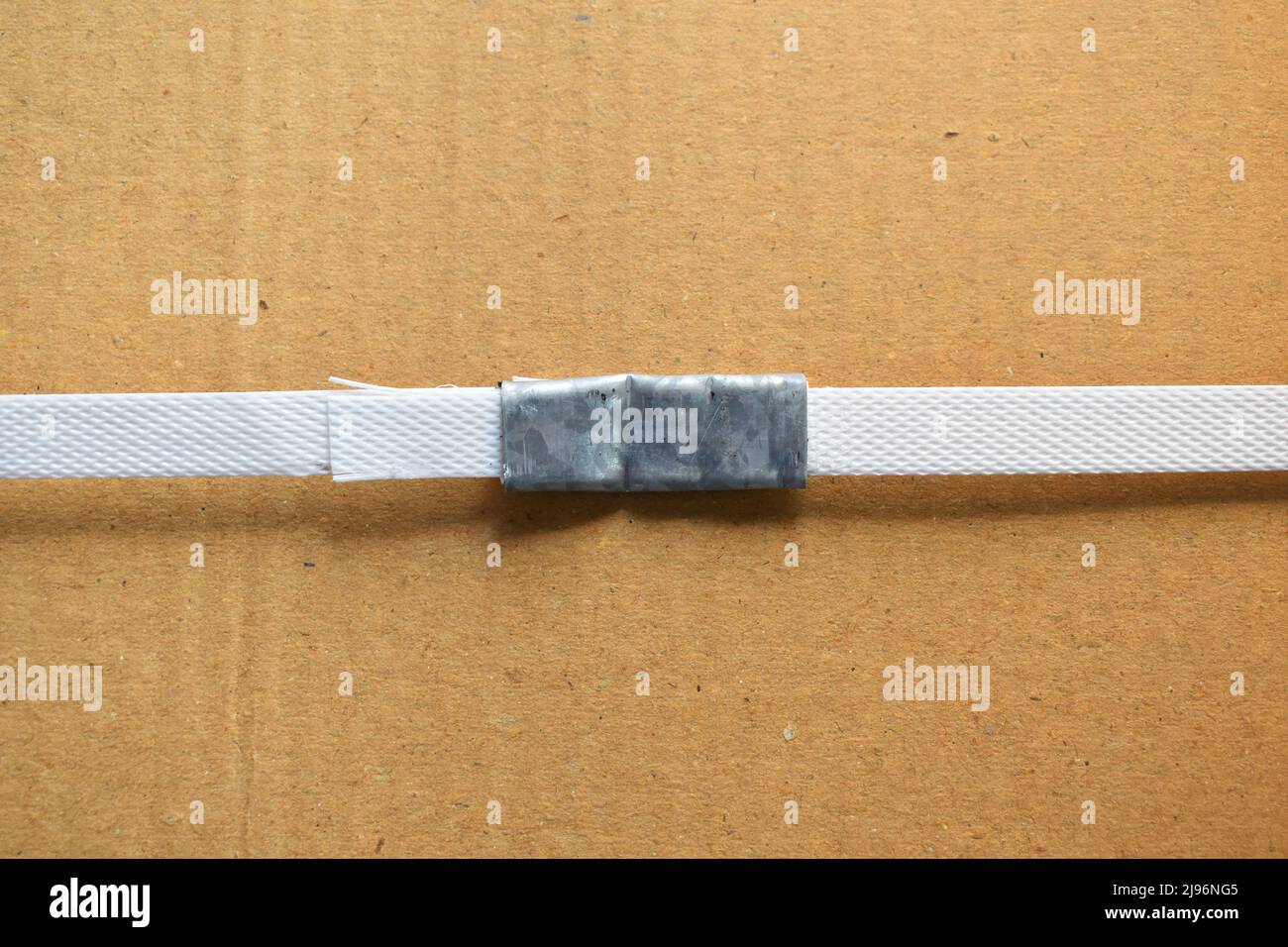 Metal closed packaging clip on cardboard box Stock Photo - Alamy