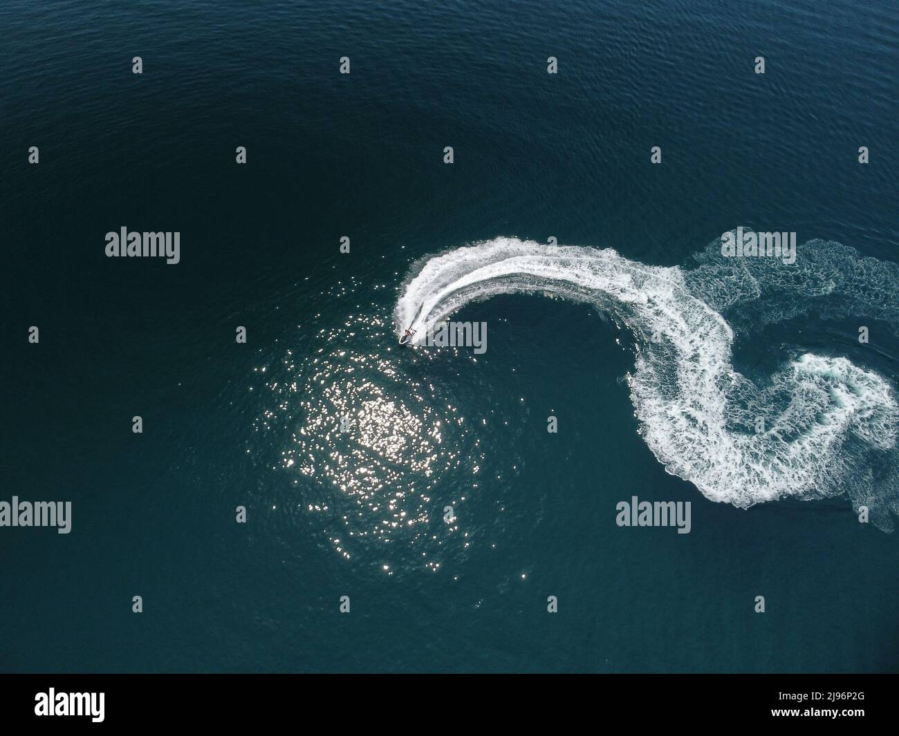 Aerial top down view of water foam trace with nice deep blue shade of ...