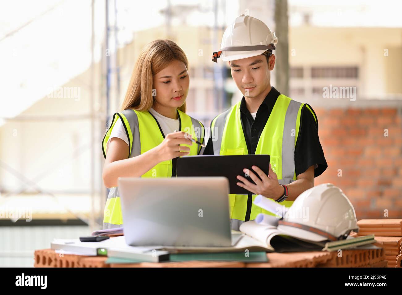 Construction engineers supervising progress of construction project ...