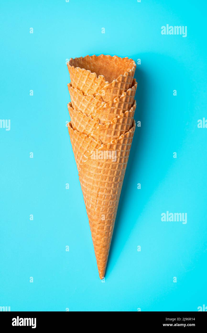 A stack of waffle cones for ice cream on a blue background Stock Photo ...