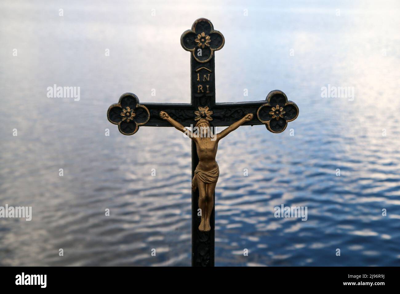 The detail of the old cross with Jesus, the christian symbol, against ...