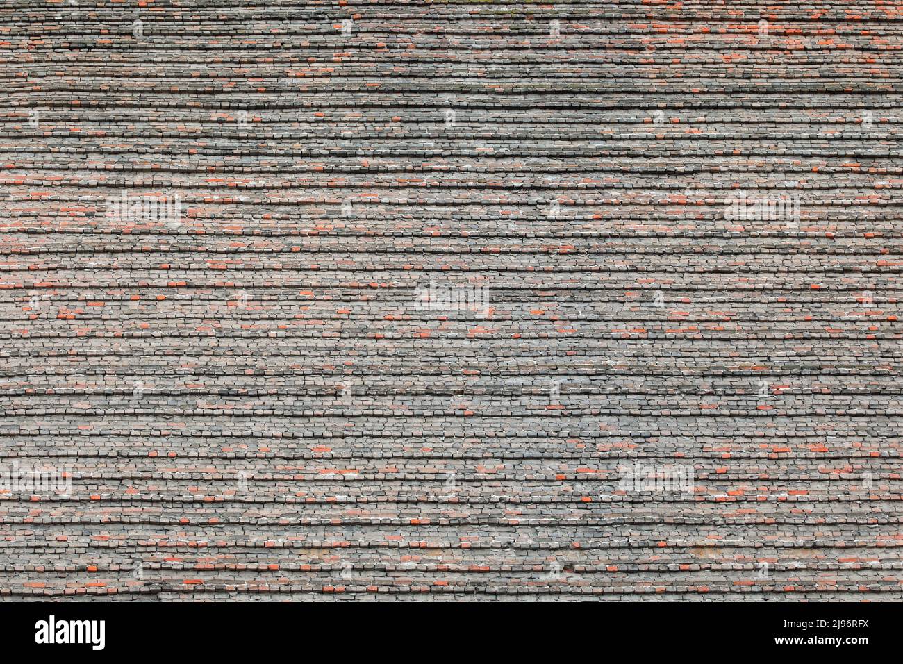 immense wide wall made of hundreds of thousands of bricks of an ancient ...