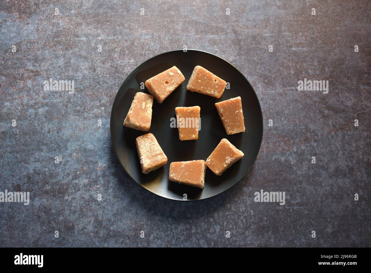 Jaggery traditional cane sugar cube Stock Photo - Alamy