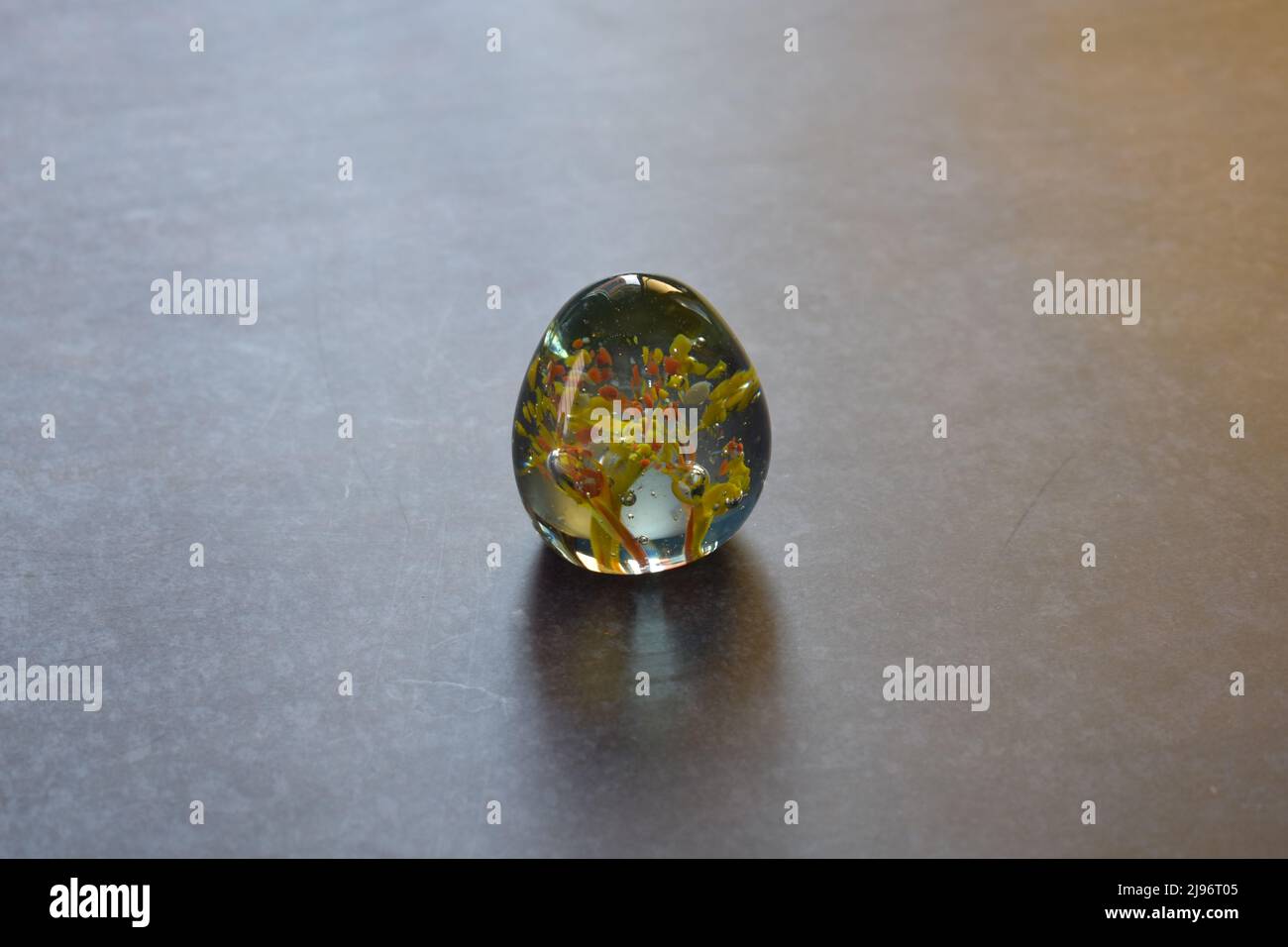 Translucent small glass paper weight Stock Photo - Alamy