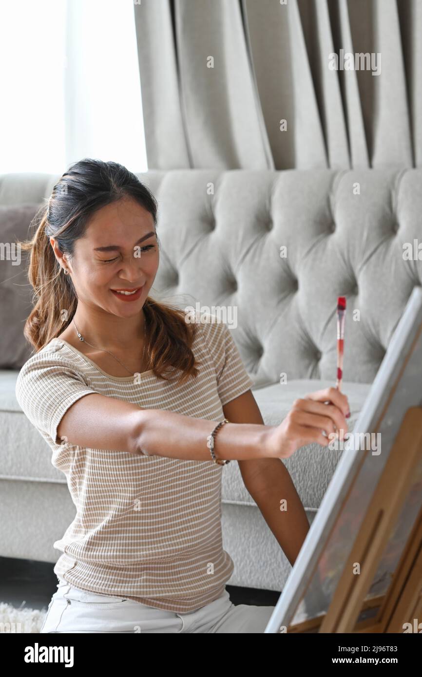 Beautiful millennial woman enjoying creative leisure activities Stock ...