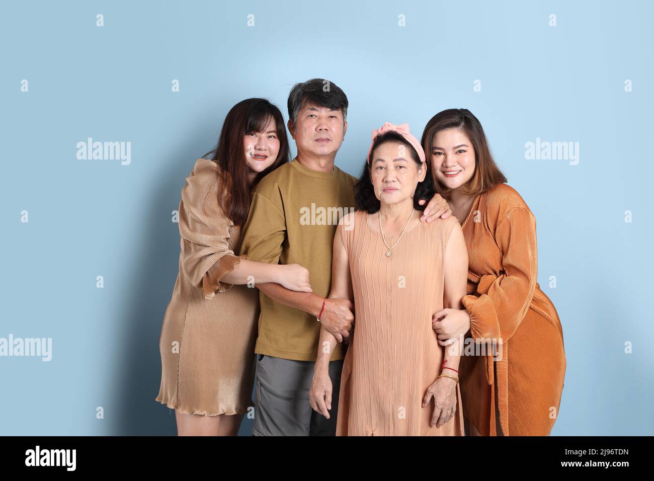 The happy Asian family standing on the blue background Stock Photo - Alamy