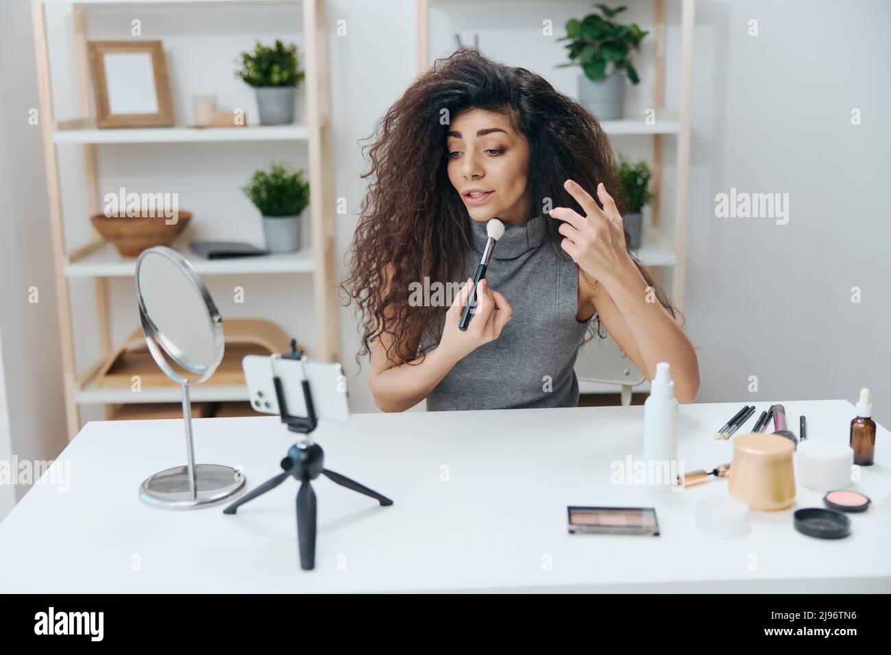 Makeup school concept. Professional visage artist tanned handsome curly ...