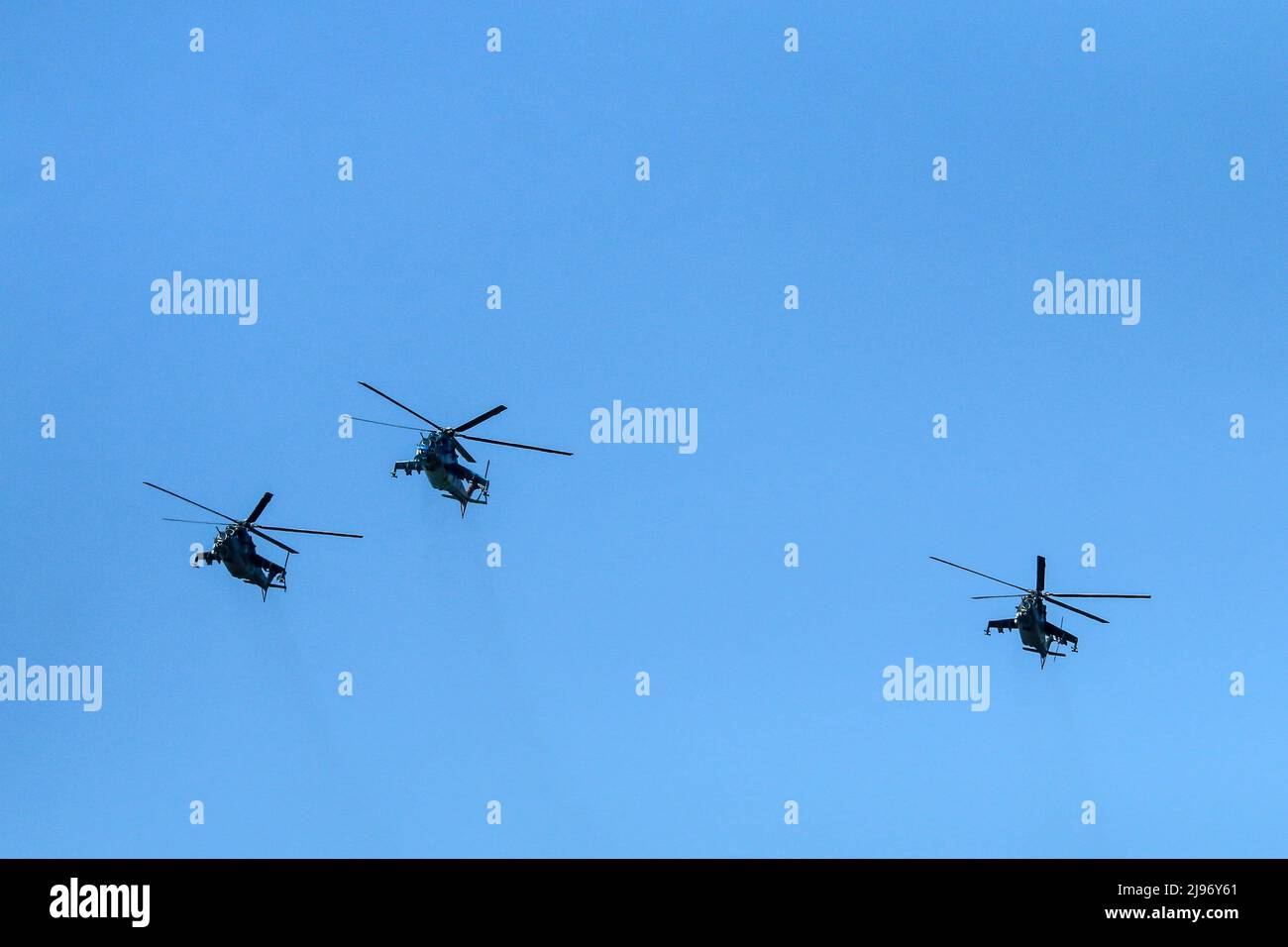 The flight of three soviet battle helicopters, type MIL Mi-24 flying on ...